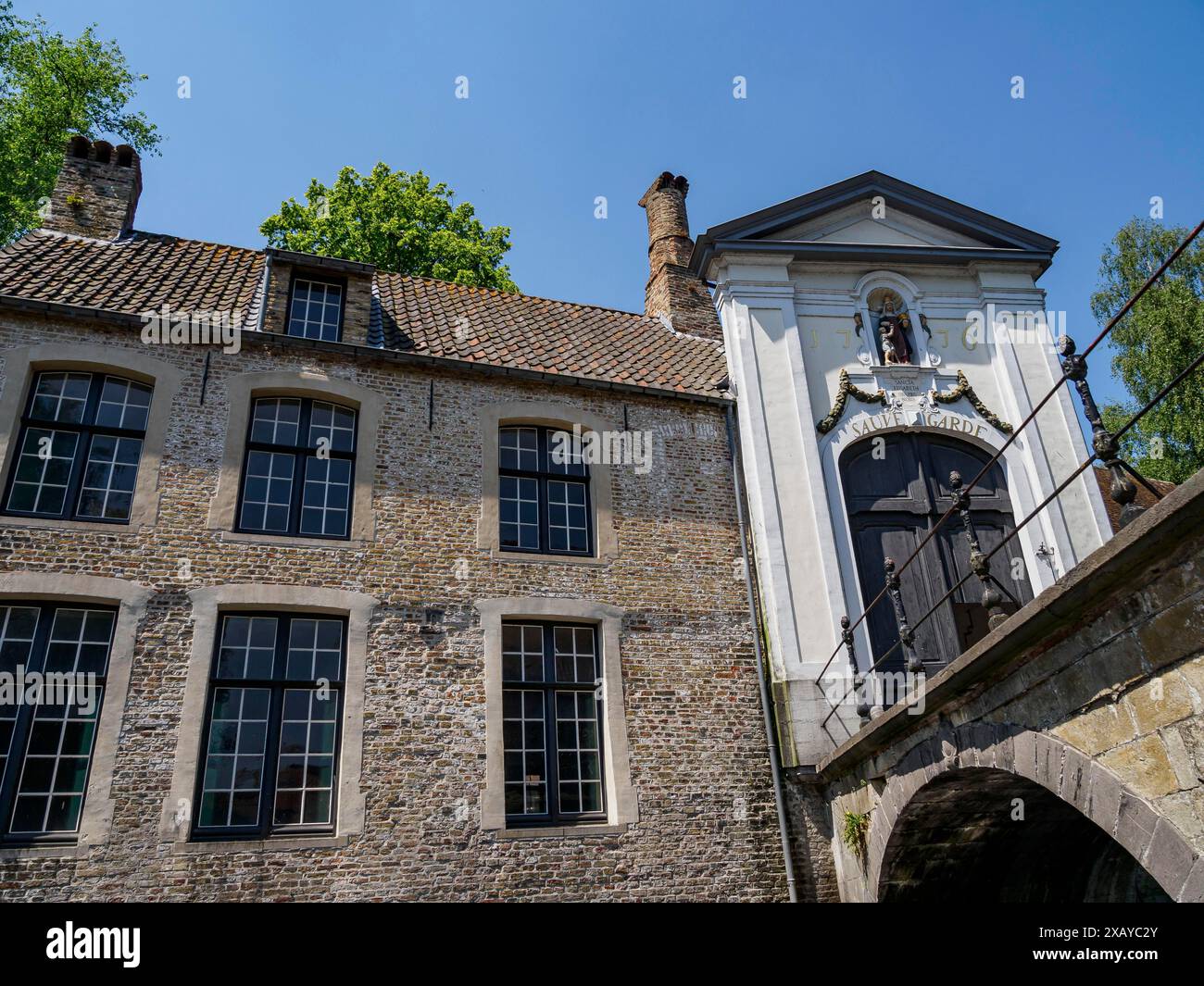 An old stone building with a white chapel, decorative windows and stone ...