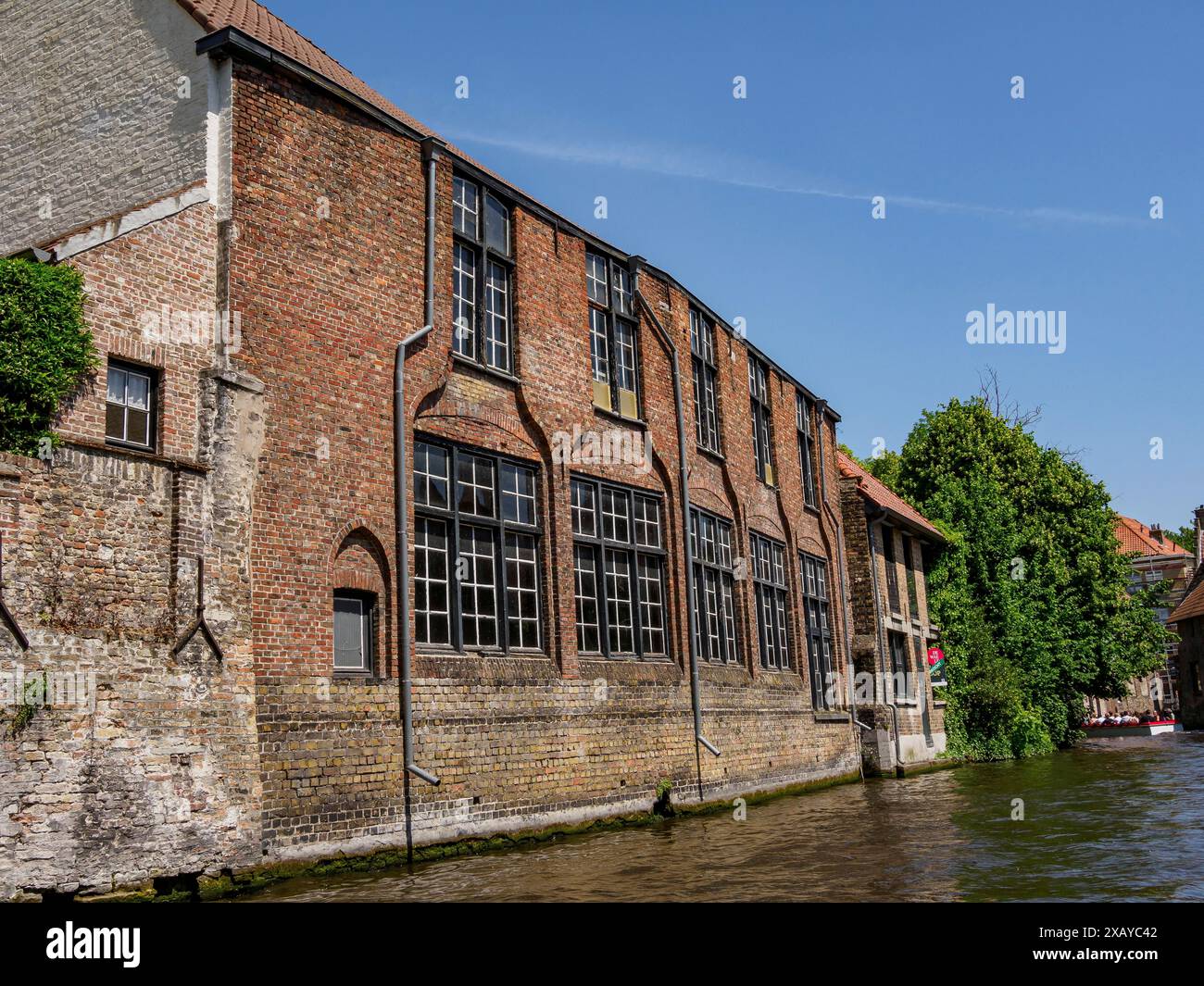 Large historic brick building with large windows on the waterfront ...