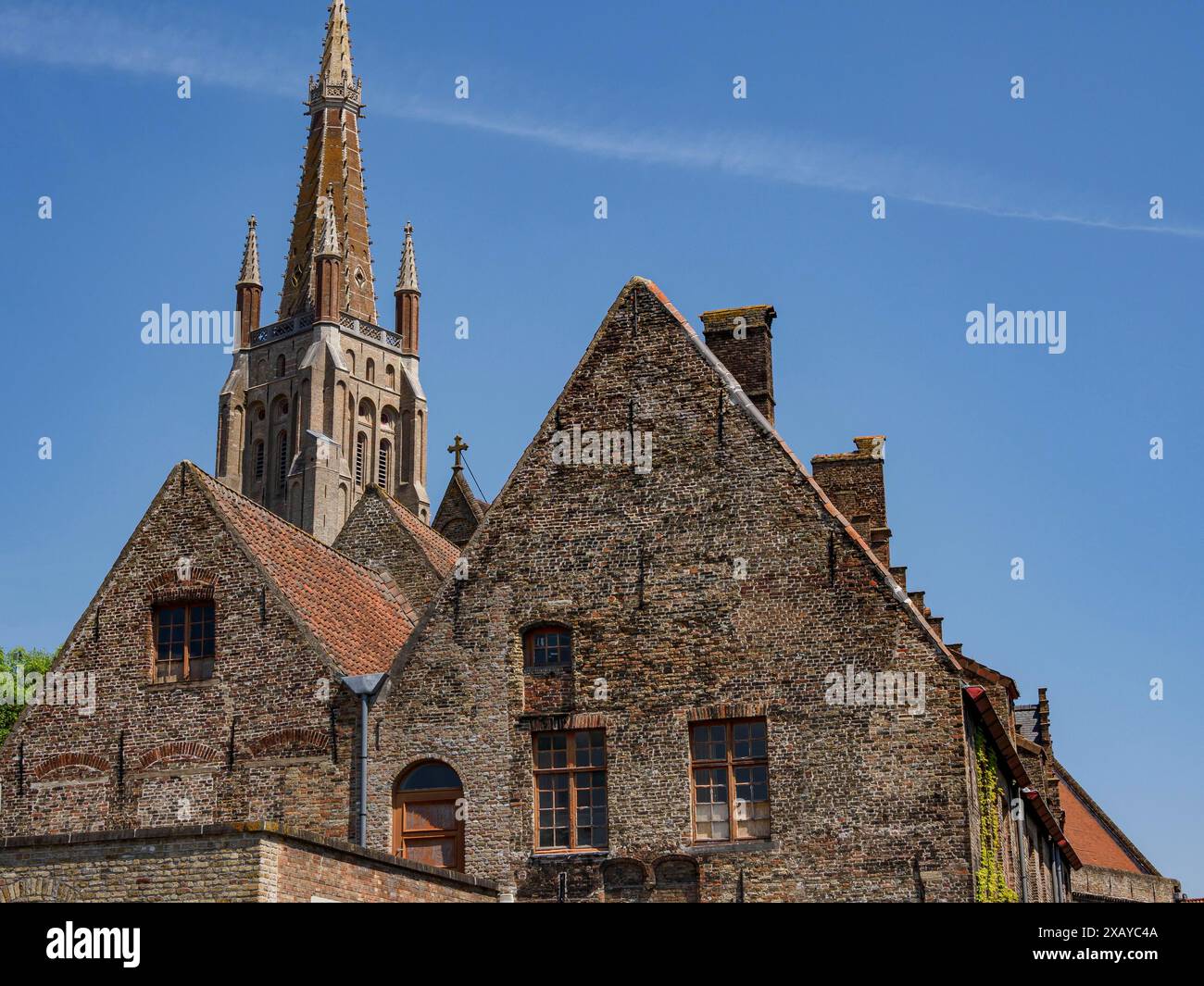 Historic church building with high towers and tiled roofs under a clear ...