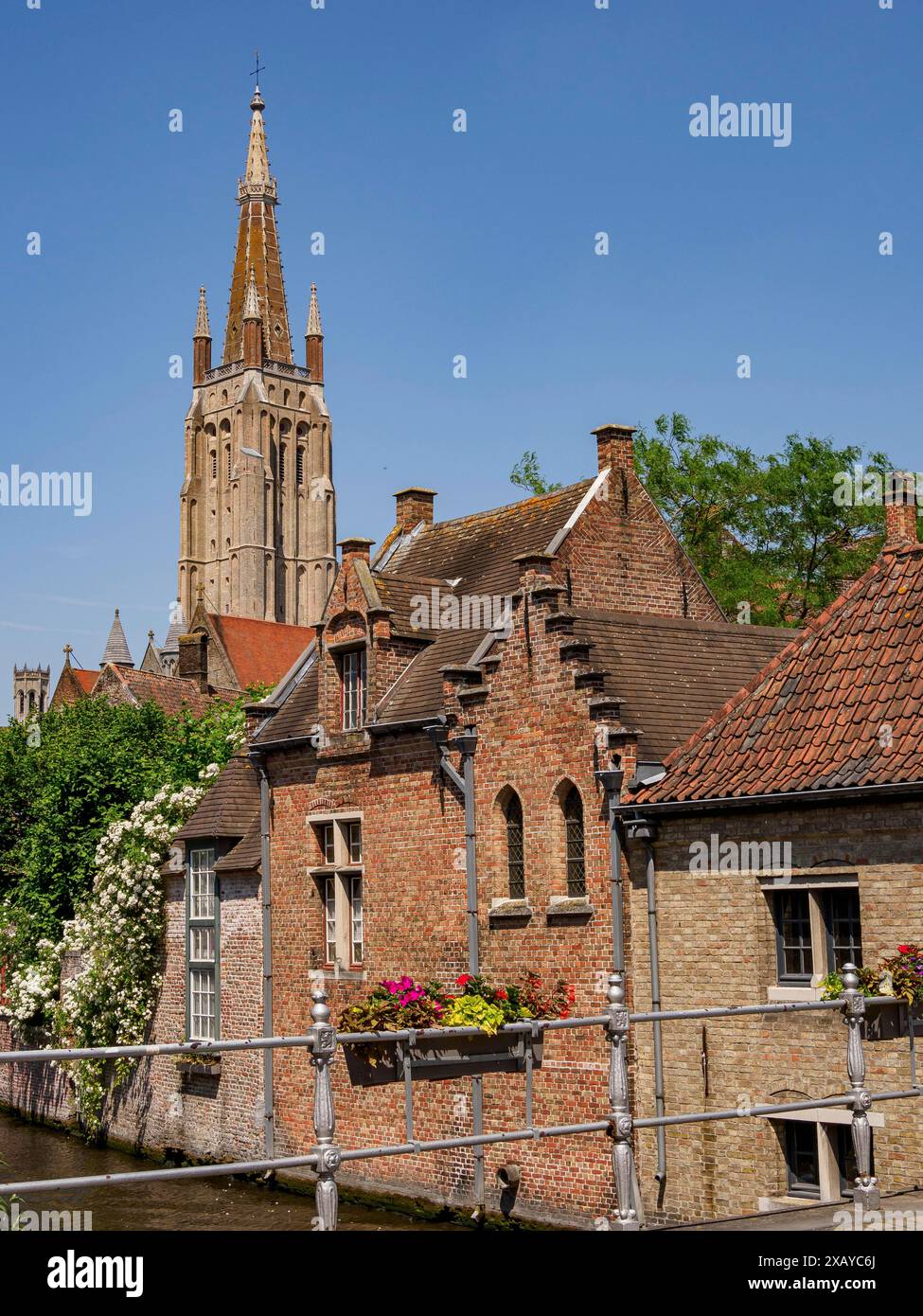 Historic buildings with brick facades and a high church tower, balcony ...