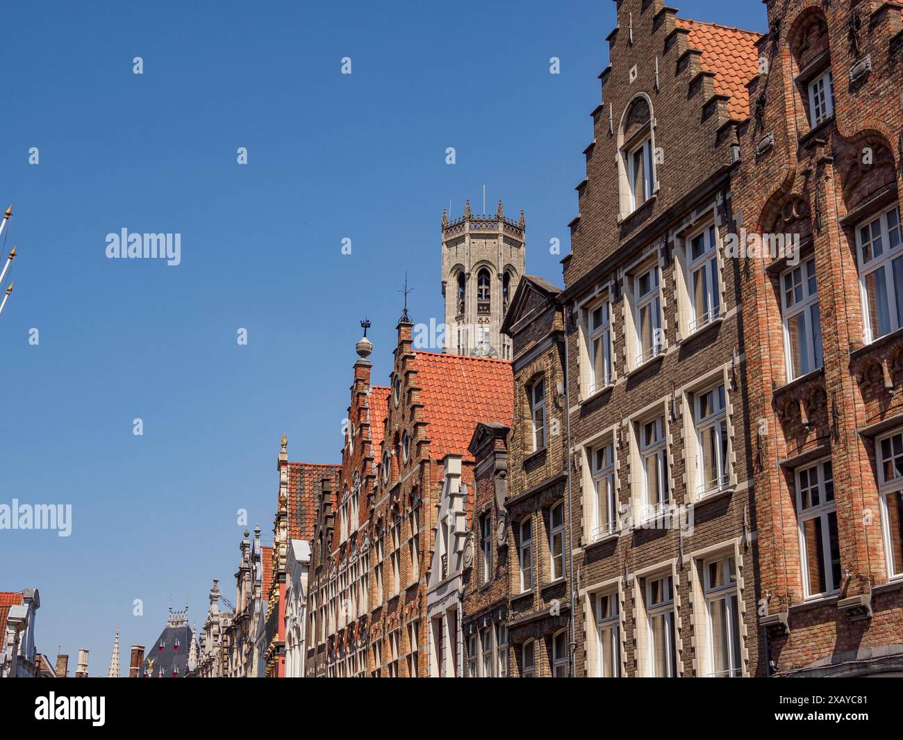 A row of old buildings with different gables and many windows under a ...