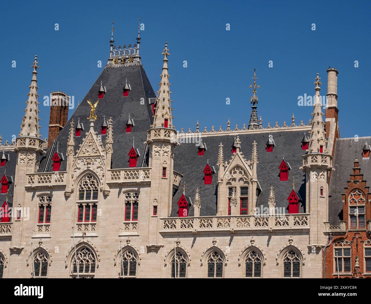 Gothic castle with striking towers, red roofs and decorative windows ...