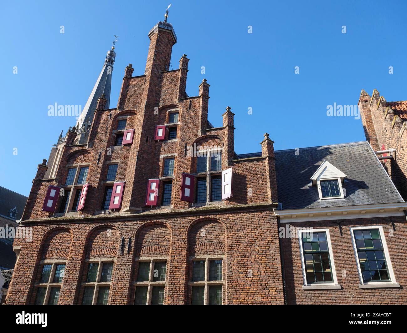 Historic brick building with windows, towering under a pristine blue ...