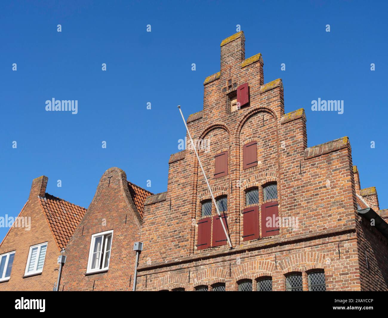 Several old buildings with striking Gothic stepped gables made of red ...
