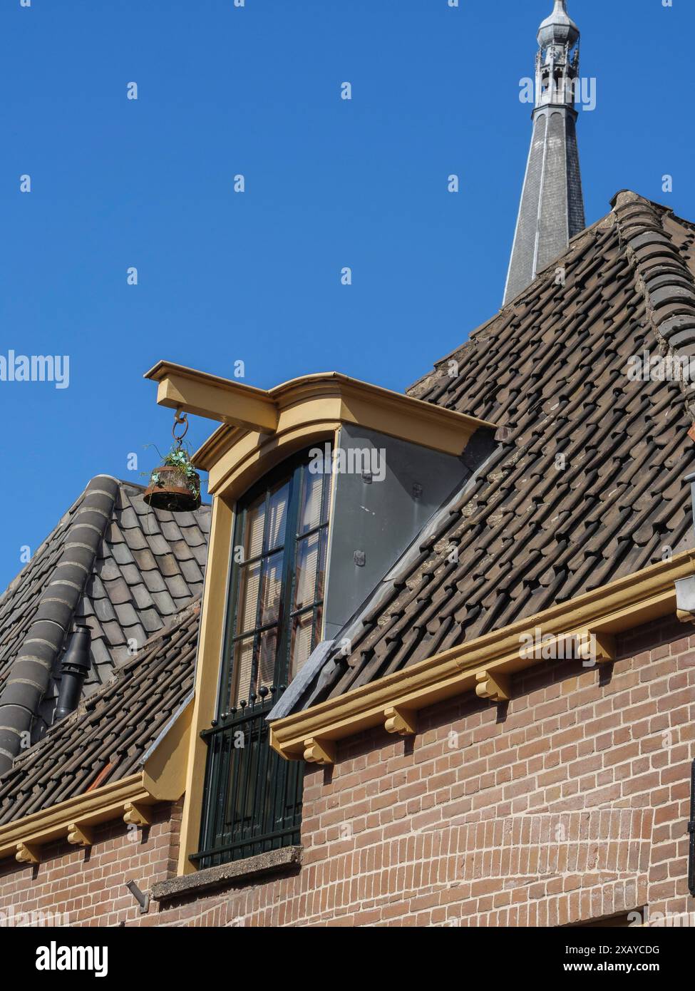Details of a dormer window and skylight of a brick building under a ...