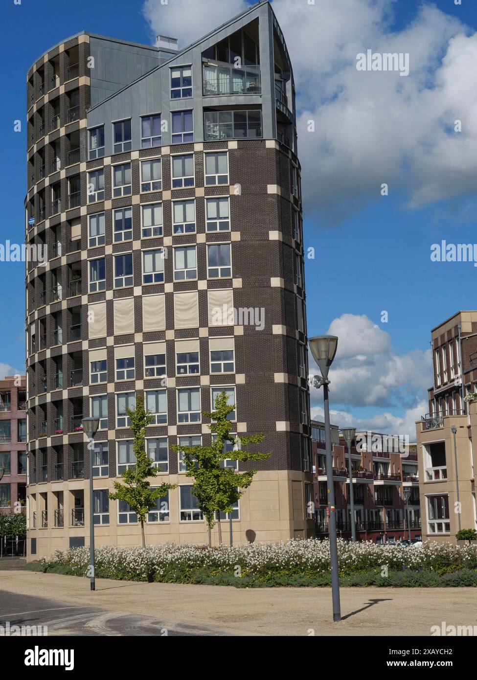 Modern residential tower block with many windows and surrounding ...