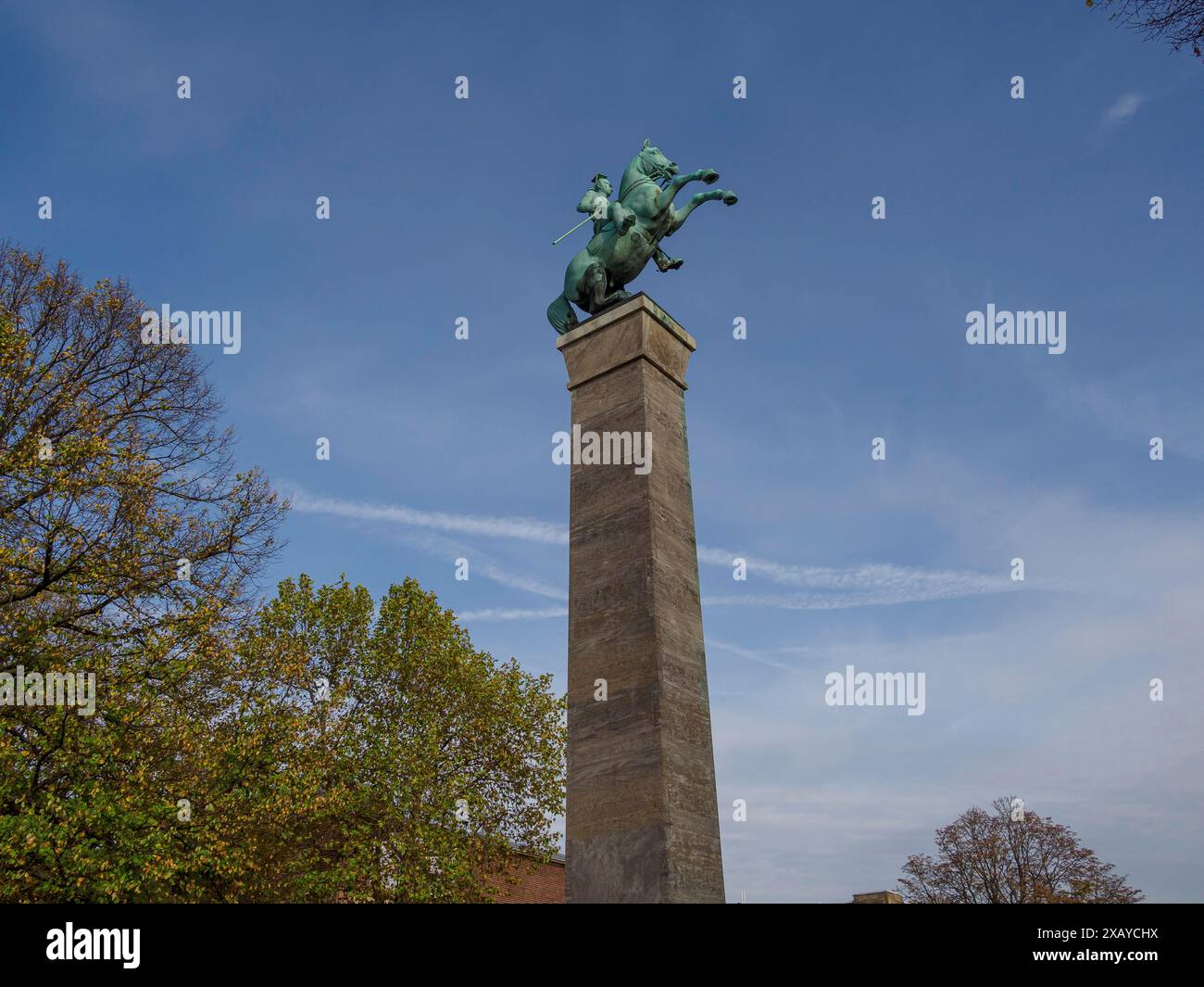 Statue of a horseman on a high column under a blue sky, surrounded by ...