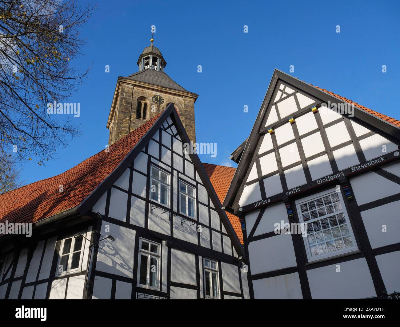 View of half-timbered houses and a church tower under a blue sky with ...