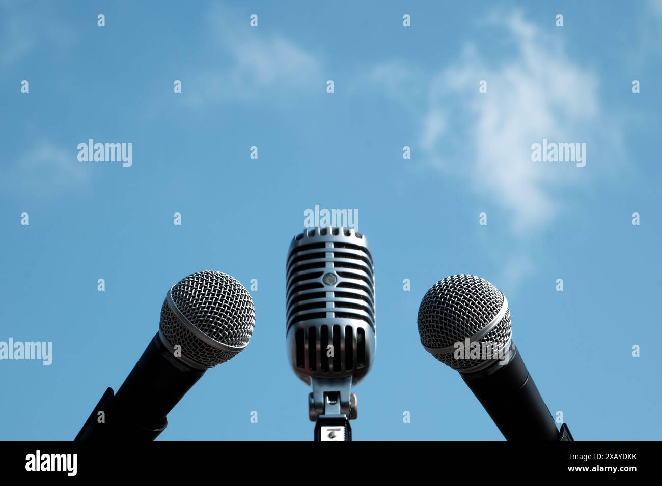 three microphones against the sky, microphones on blue background Stock ...
