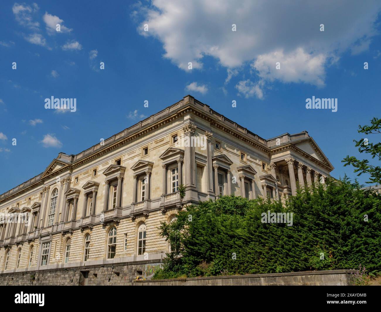 Large, neoclassical building with columns and many windows, under a ...