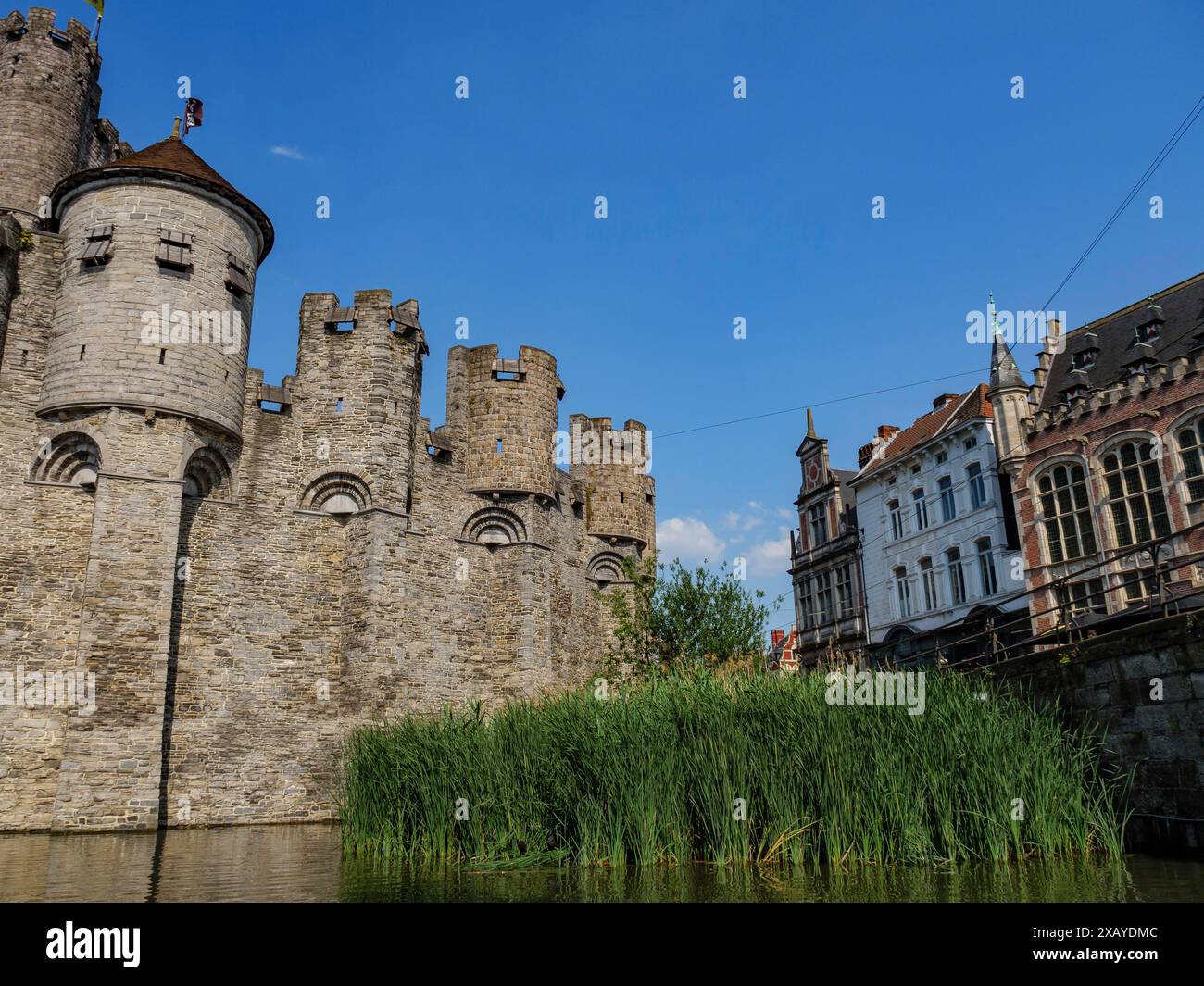 Medieval castle with towers next to a historic building on the ...