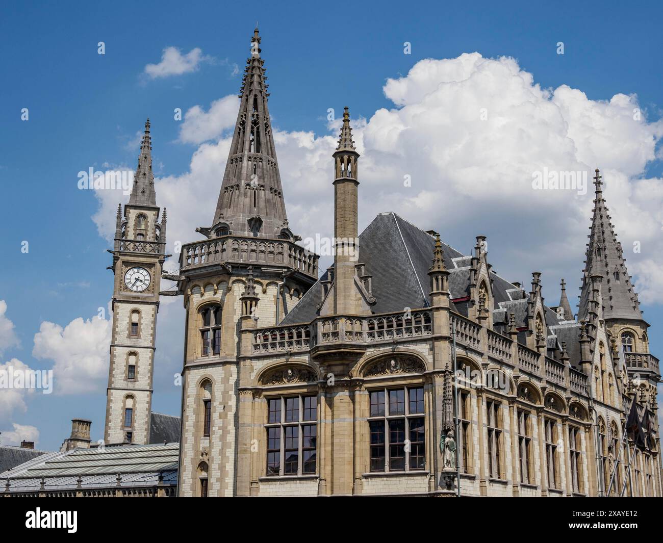 Gothic-style building with high towers under a slightly cloudy sky ...