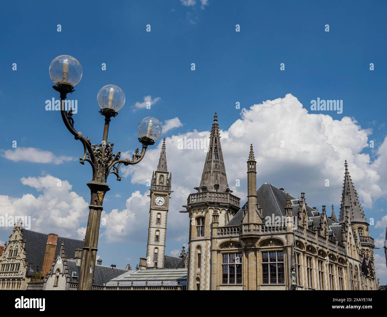 Street lamp in front of Gothic historic buildings with towers and bell ...