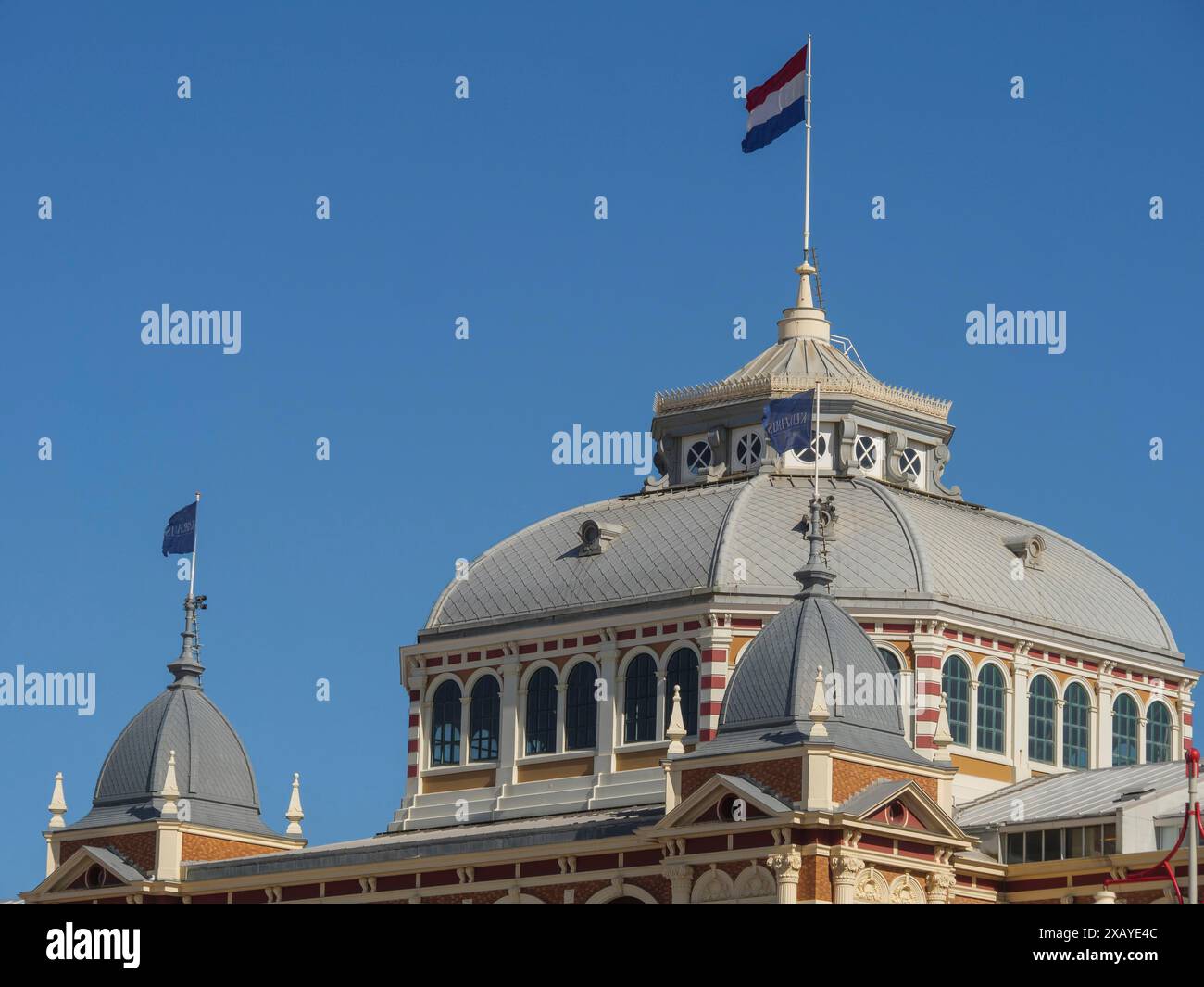 Traditional buildings with Dutch flag in front of a clear sky ...