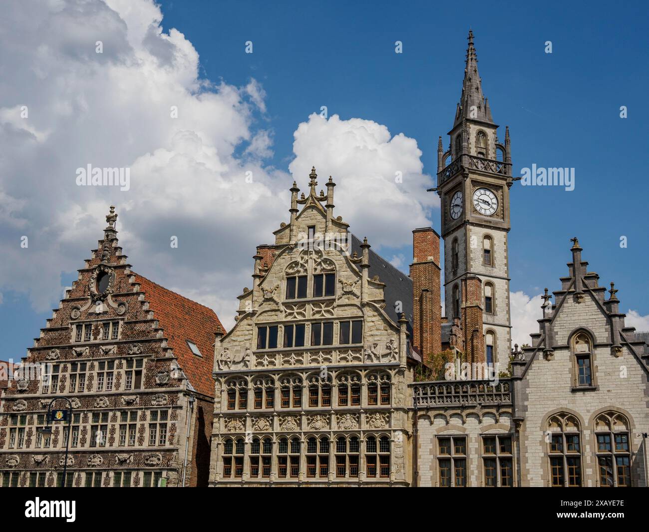 Historic buildings and towers in a Gothic style under a sky with clouds, Ghent, Belgium Stock ...