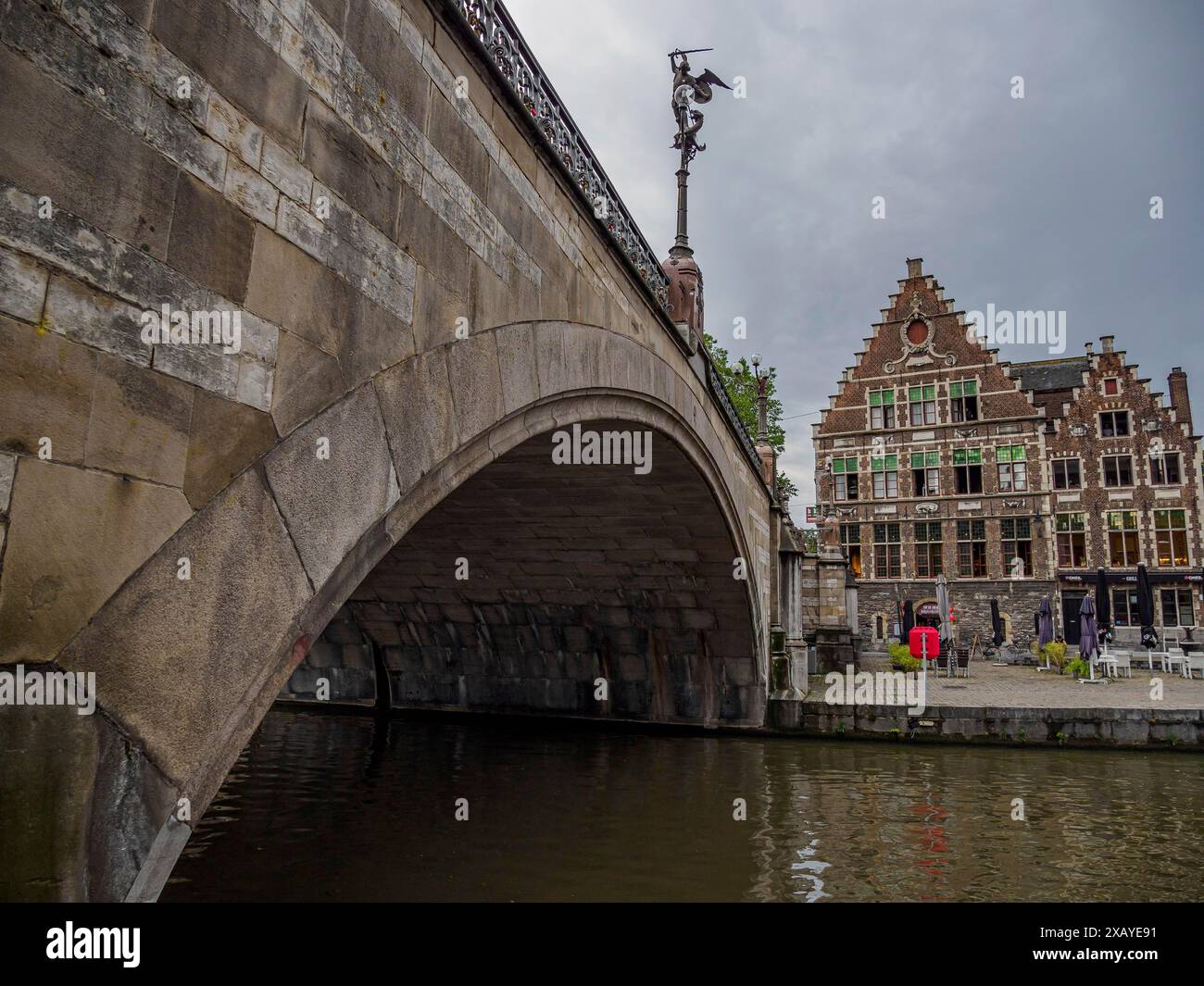 Historic bridge with neighbouring buildings and cloudy sky in the old ...