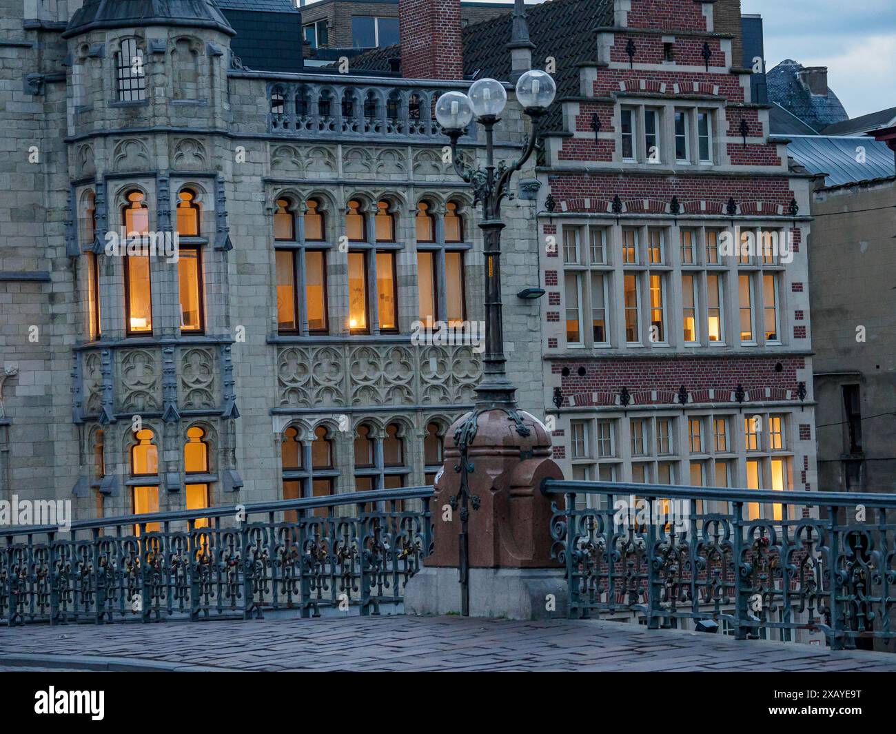 Close-up of historic buildings with illuminated windows and a lantern ...