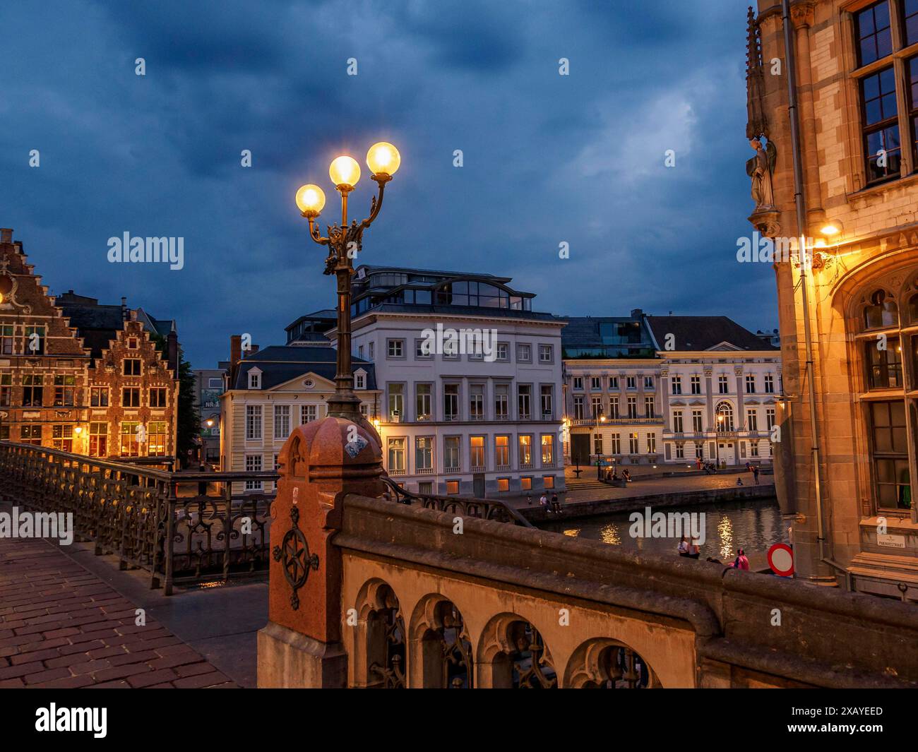 Illuminated canal and historic buildings at night with streetlights ...