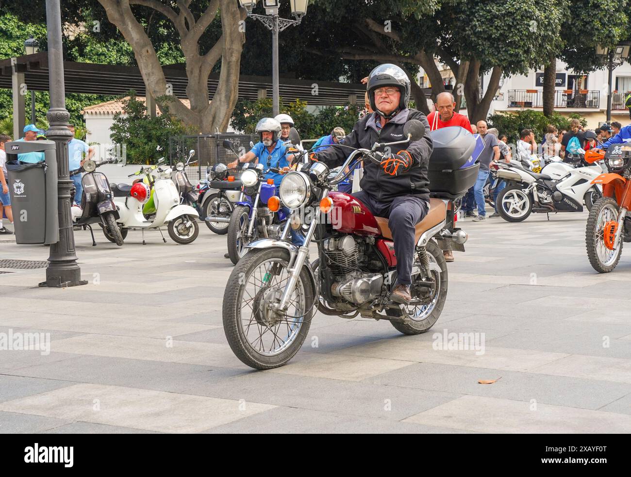 Man riding a classic Yamaha motorcycle at an annual Classic motorcycle ...
