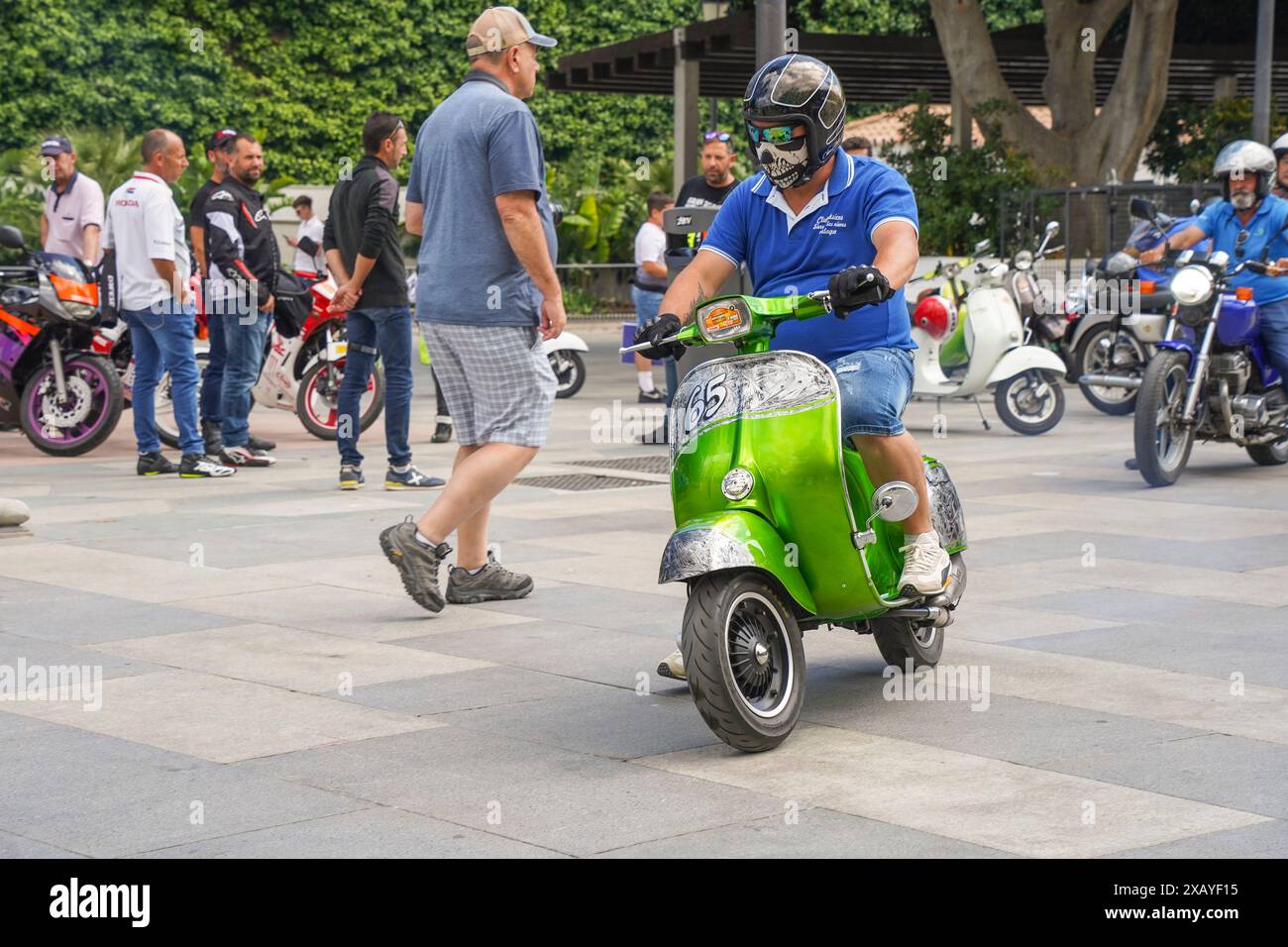 Man driving a classic Vespa scooter at an annual Classic motorcycle ...
