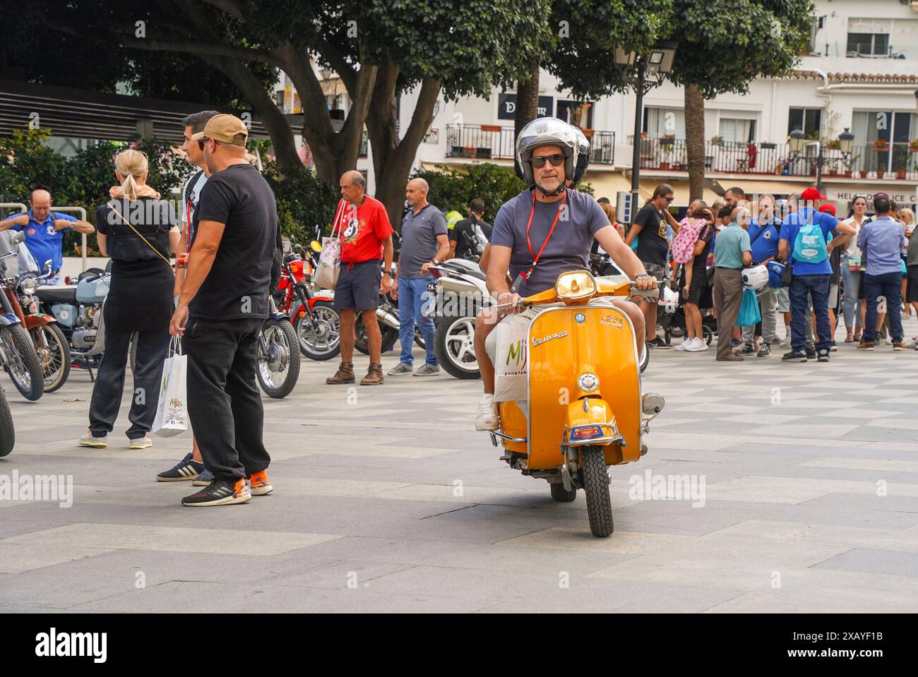 Man riding a classic Vespa scooter at an annual Classic motorcycle ...