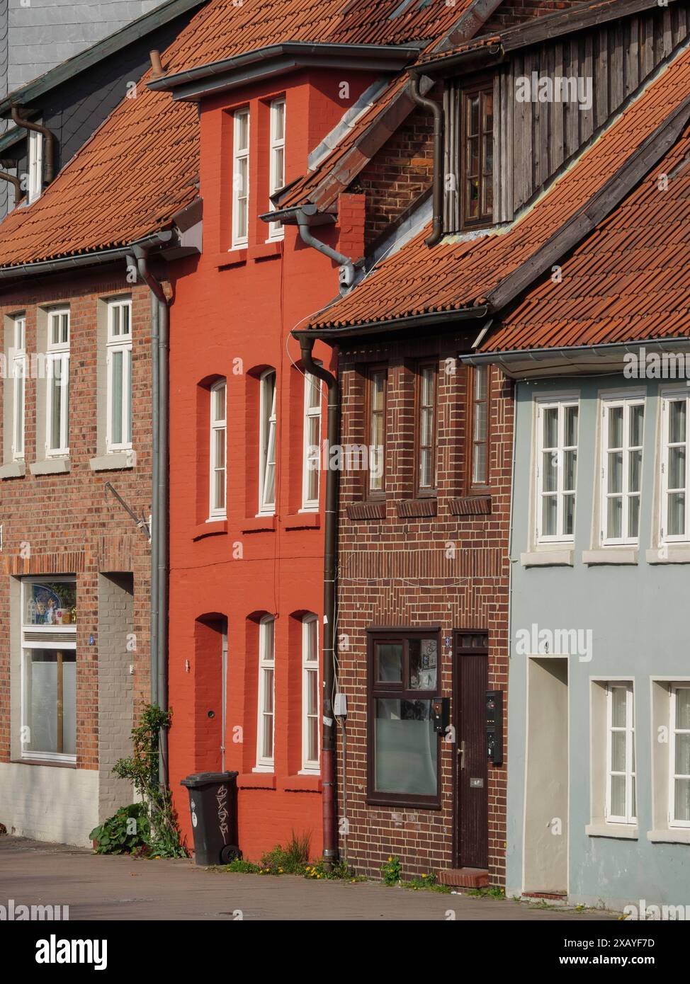 Historic townhouses with red tiled roofs and brick walls in a well ...