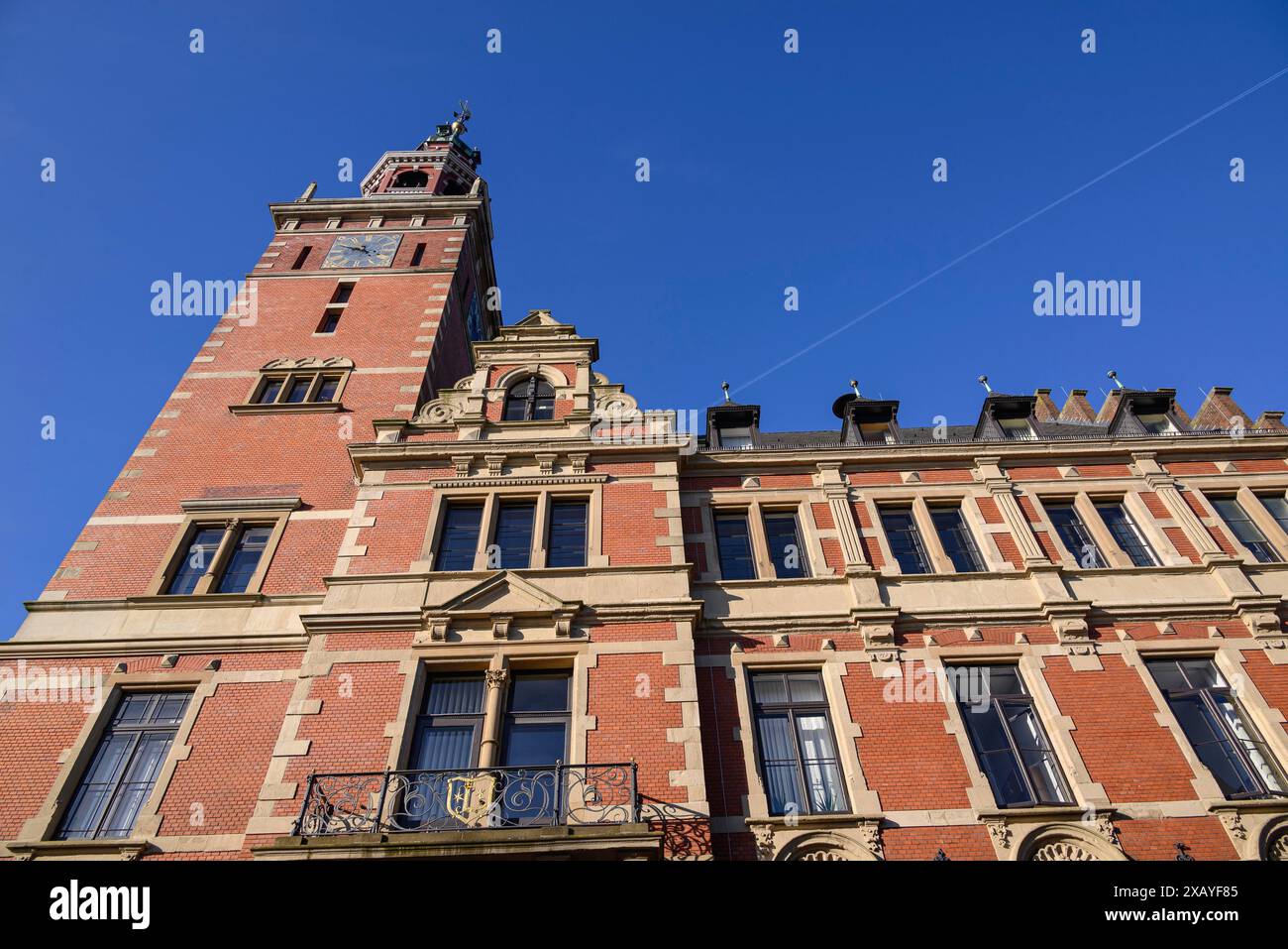 Proud historic building with tower and many windows under a bright blue ...