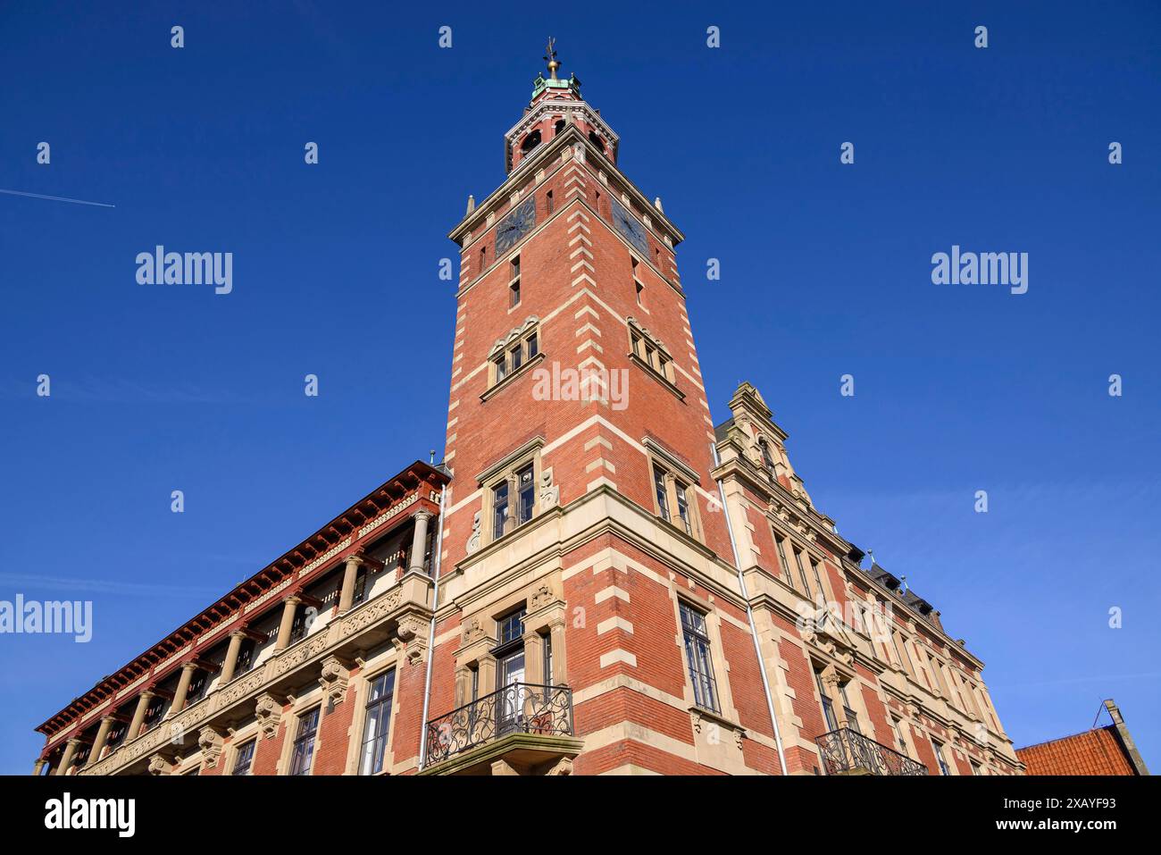 High brick tower of a historic building under a clear blue sky, Leer ...