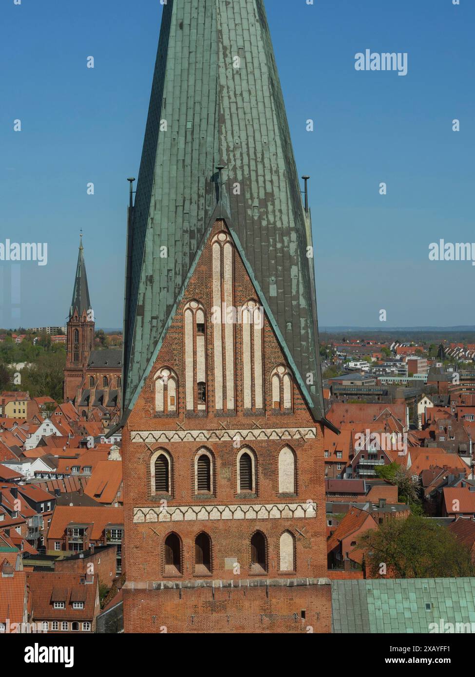 Large Gothic brick church tower in an old town with predominantly red ...