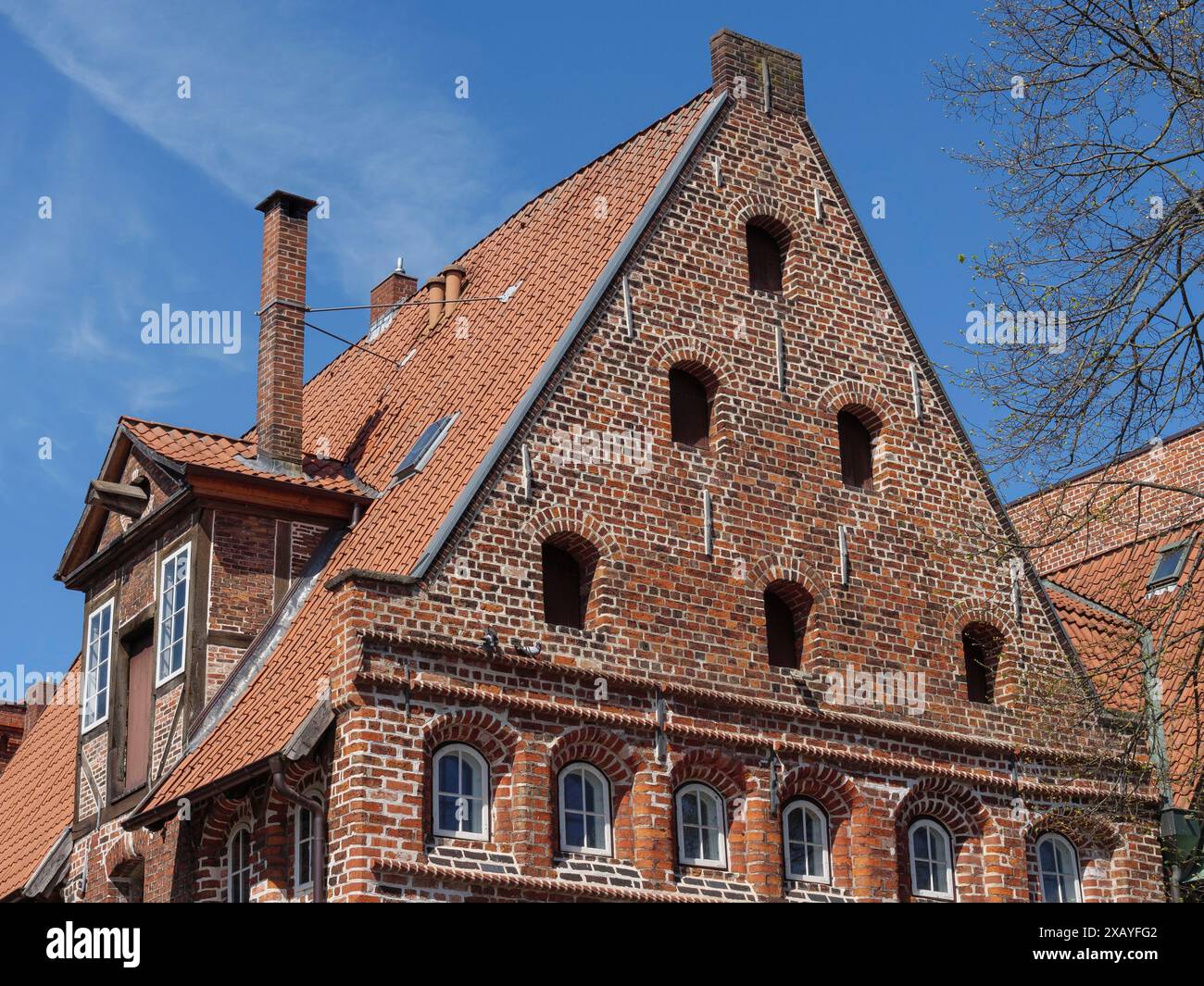 Medieval brick gabled house with characteristic windows and blue sky ...