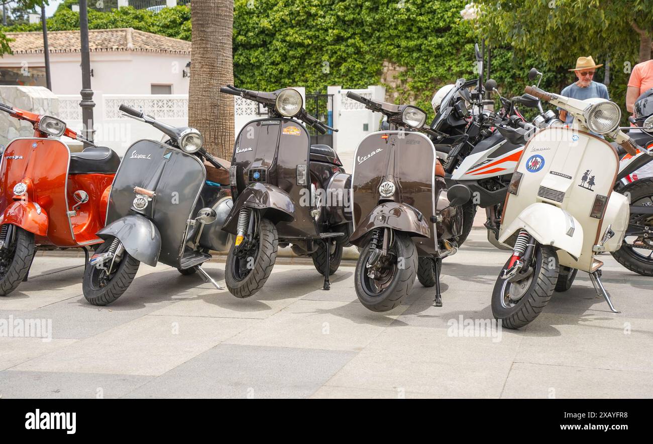 Row of classic Vespa scooters on display at an annual Classic ...