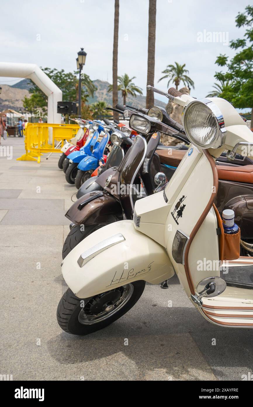 Row of classic Vespa scooters on display at an annual Classic ...