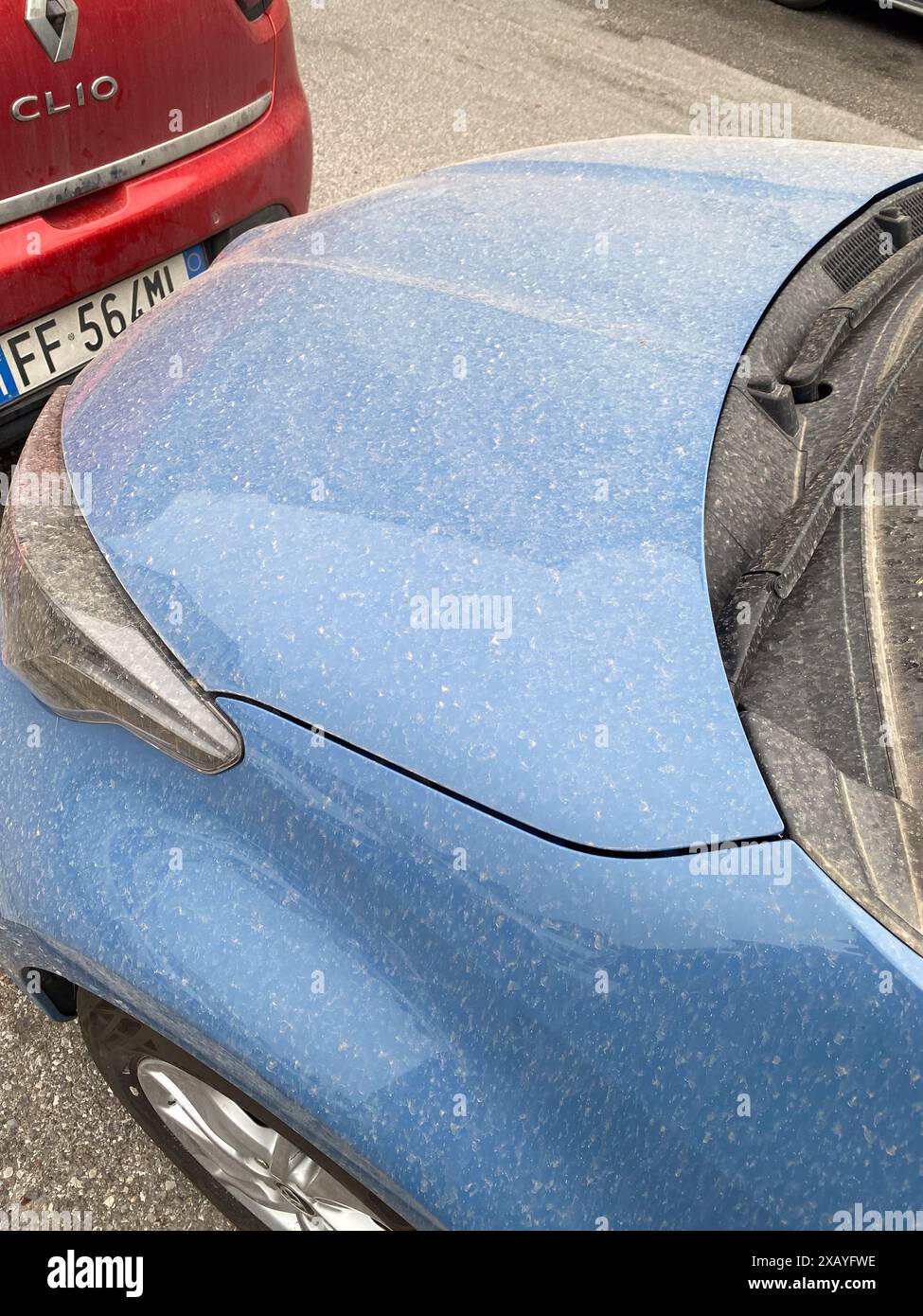Cremona, Italy - June 9th 2024 Dusty blue car parked in a desert lot ...