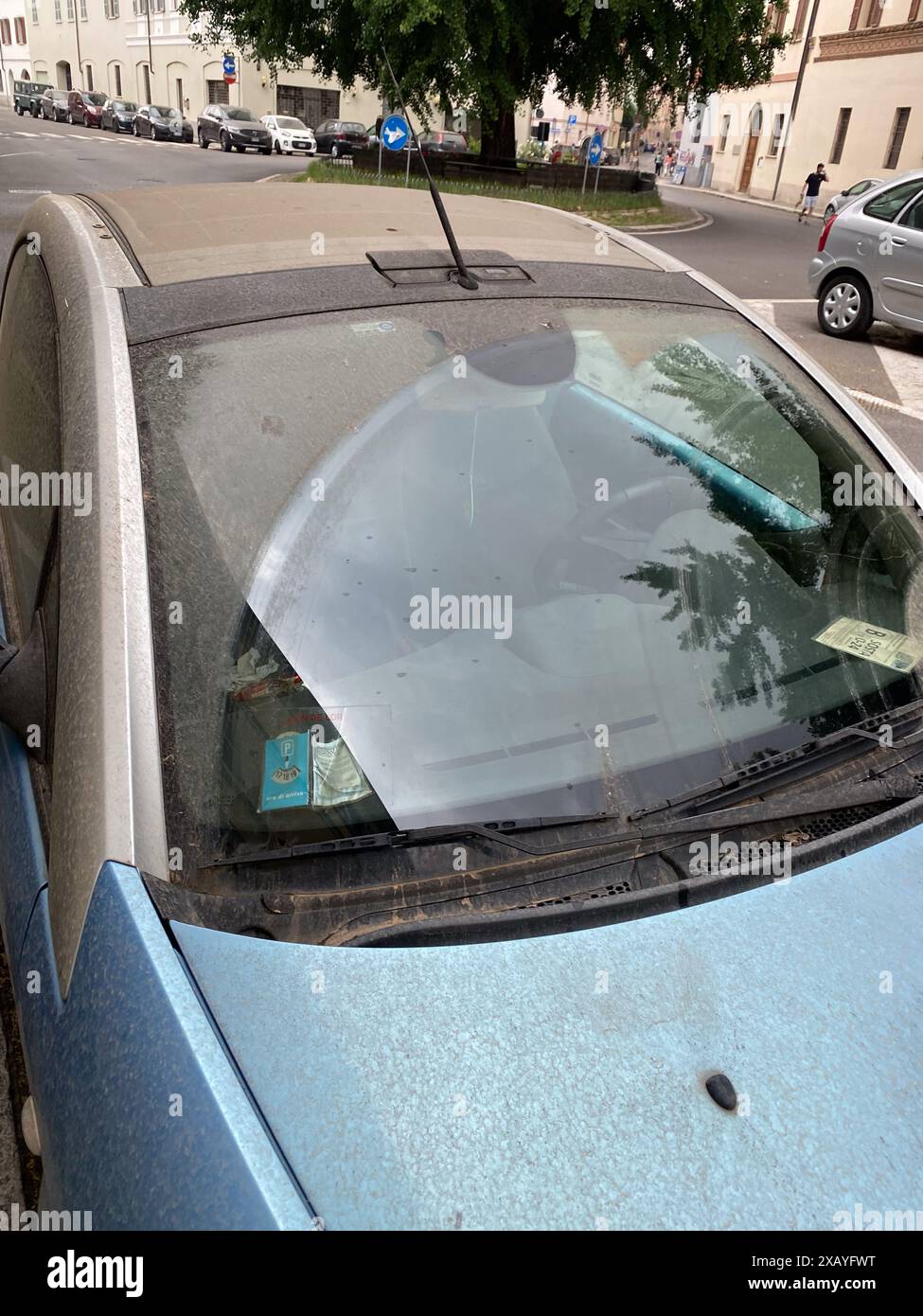 Cremona, Italy - June 9th 2024 Dusty blue car parked in a desert lot ...