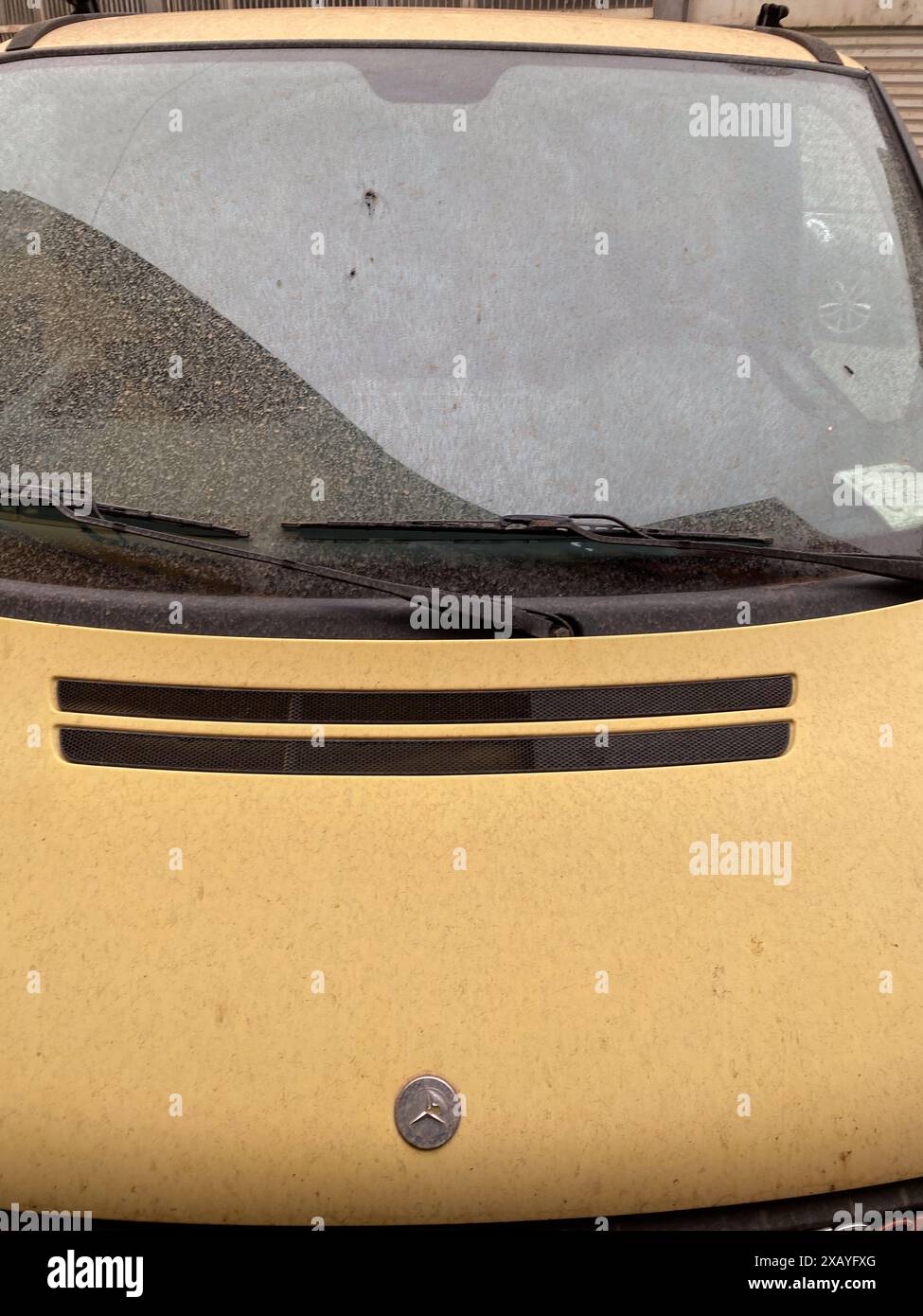 Cremona, Italy - June 9th 2024 Dusty yellow cargo van parked on a city ...