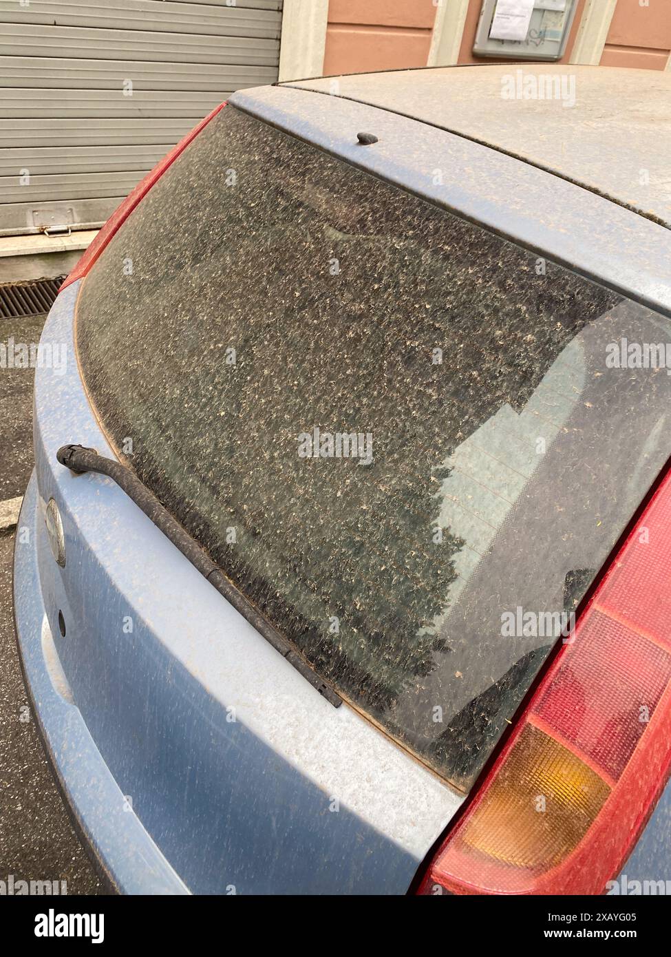 Cremona, Italy - June 9th 2024 Dusty blue car parked in a desert lot ...