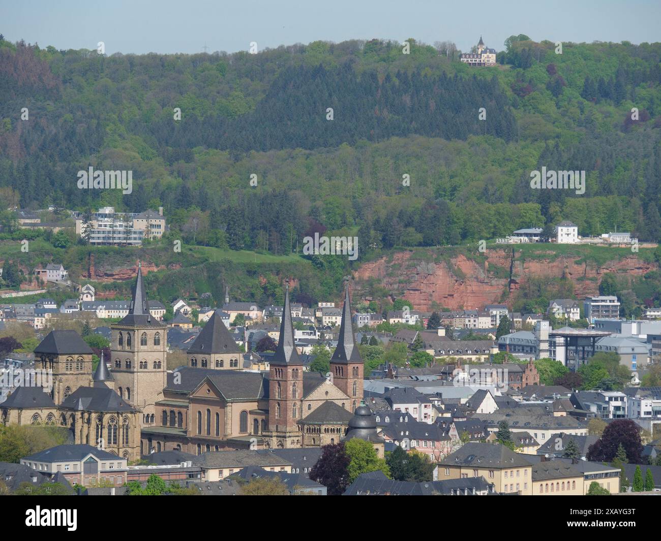 Historic buildings and church towers in a city surrounded by green ...
