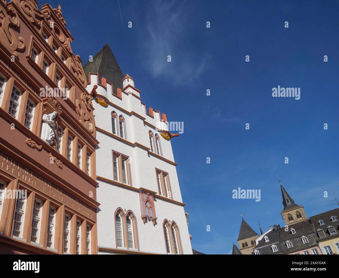 Historic buildings with church towers under a clear blue sky, trier ...