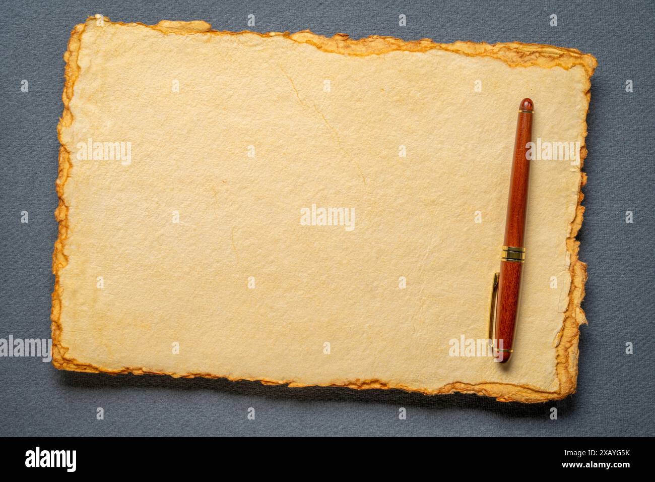 stack of tan toned heavyweight deckle edge paper sheets with a stylish ...