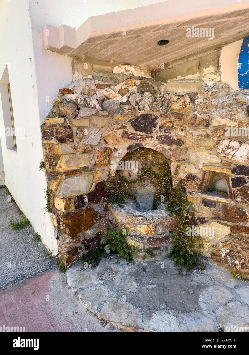 Old well at the corner of the house next to the historic small single-nave church Panagia ...