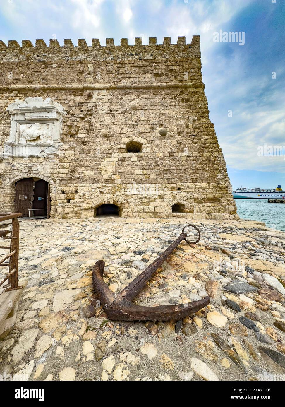 Old historical cane anchor made of iron slightly rusty in front of main ...