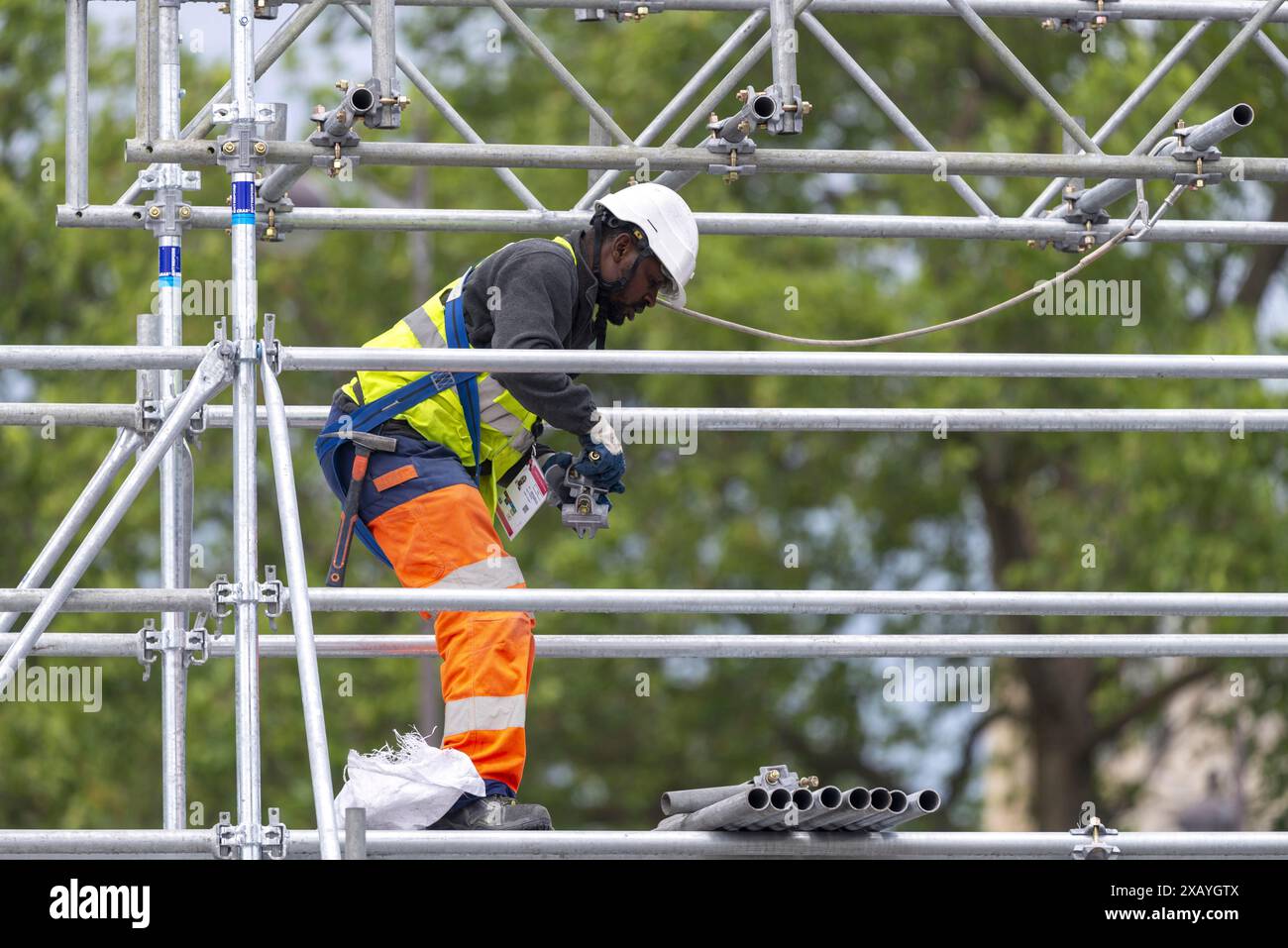 Scaffolders at work, erecting a large scaffold, grandstands for the ...