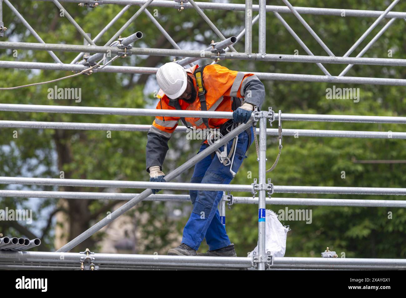 Scaffolders at work, erecting a large scaffold, grandstands for the ...