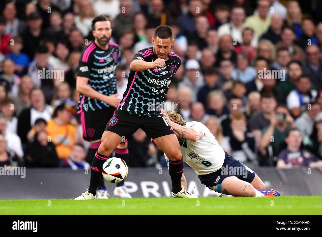 World XI's Eden Hazard (left) and England's Stuart Broad battle for the ...