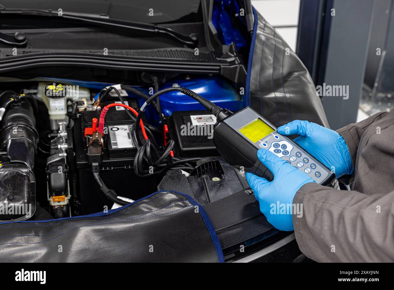 Car master mechanic checking and testing automotive battery with ...