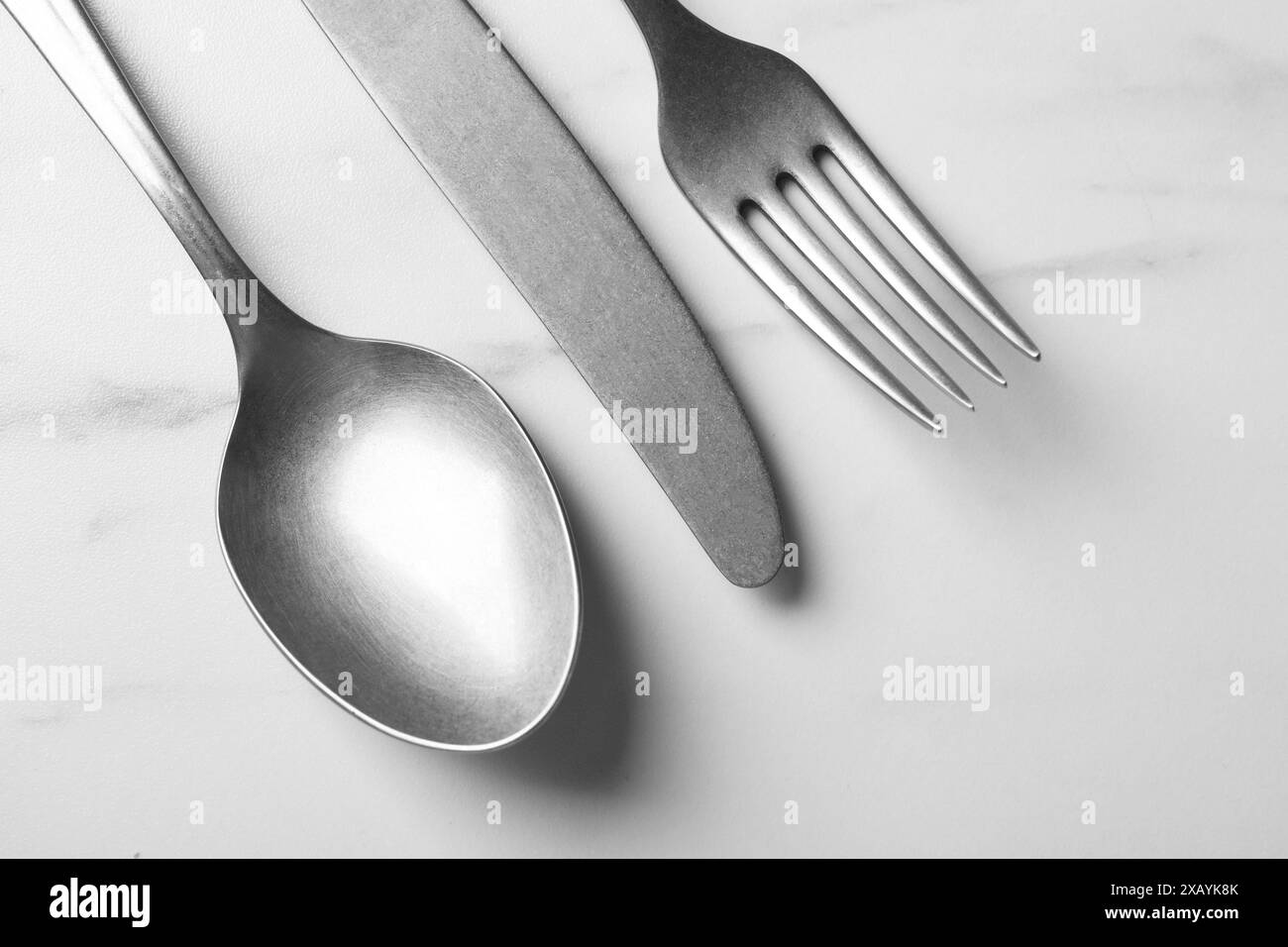 Stylish silver cutlery set on white marble table, flat lay Stock Photo ...