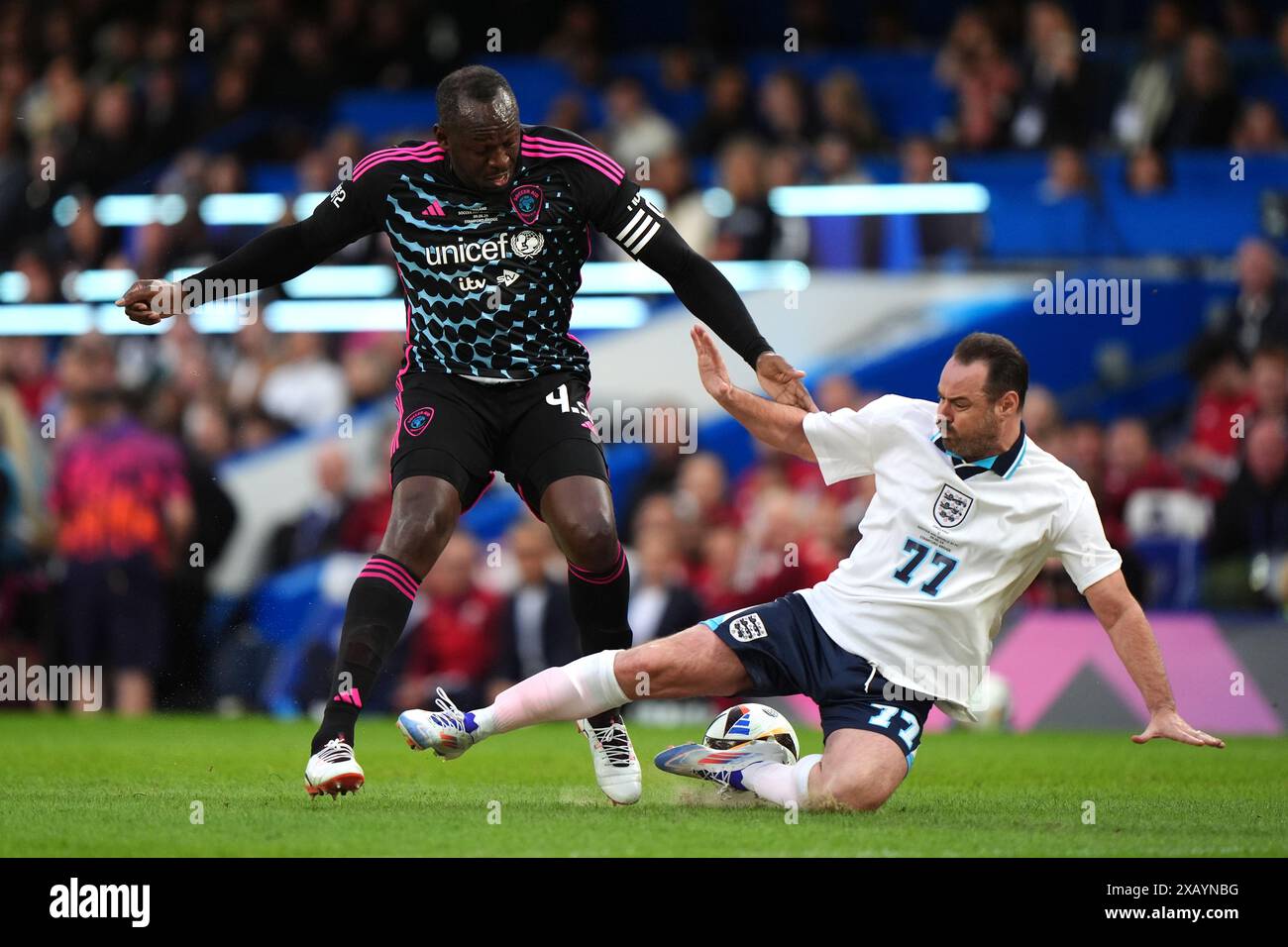 World XI's Usain Bolt (left) is challenged by England's Danny Dyer ...