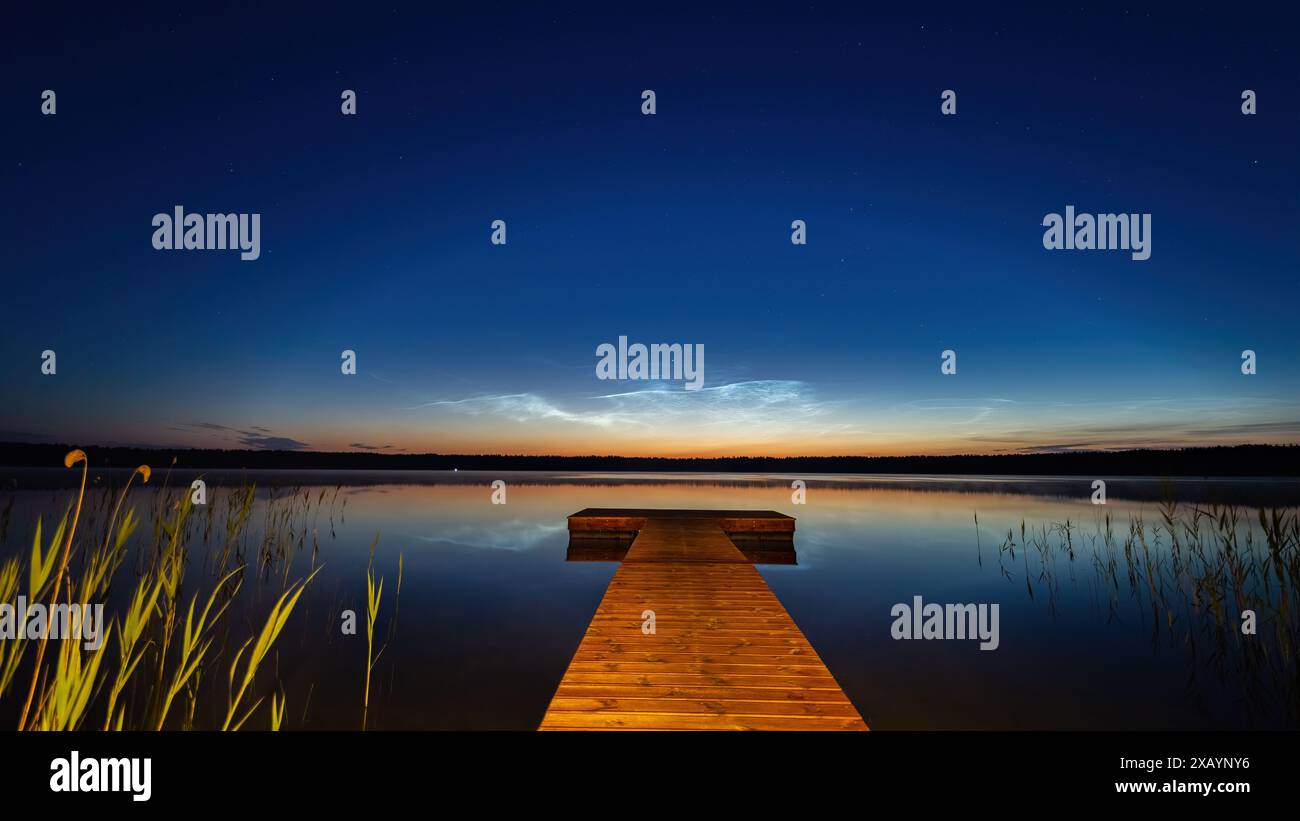 Night sky with noctilucent clouds on lake bridge Stock Photo - Alamy