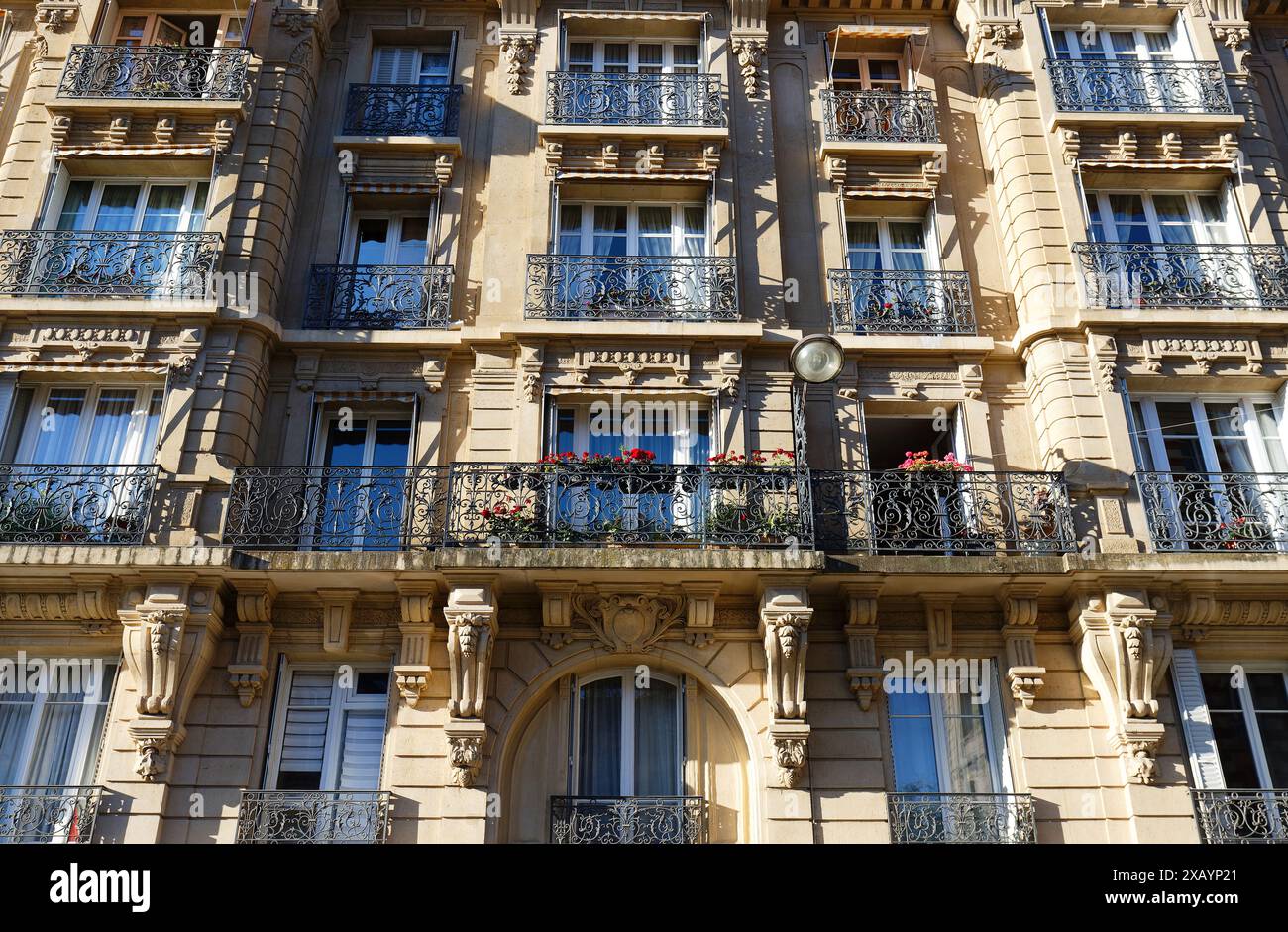 The facade of traditional French house with typical balconies and ...