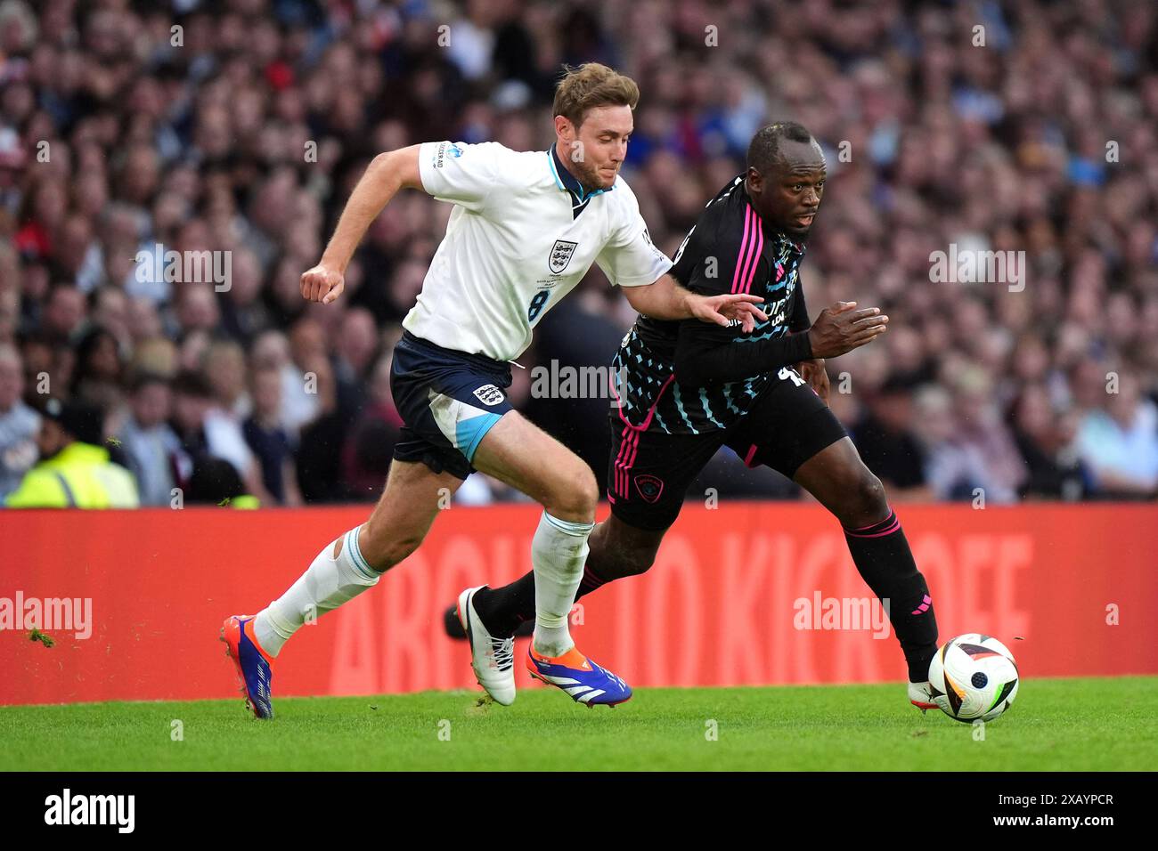 England's Stuart Broad (left) and World XI's Usain Bolt battle for the ...